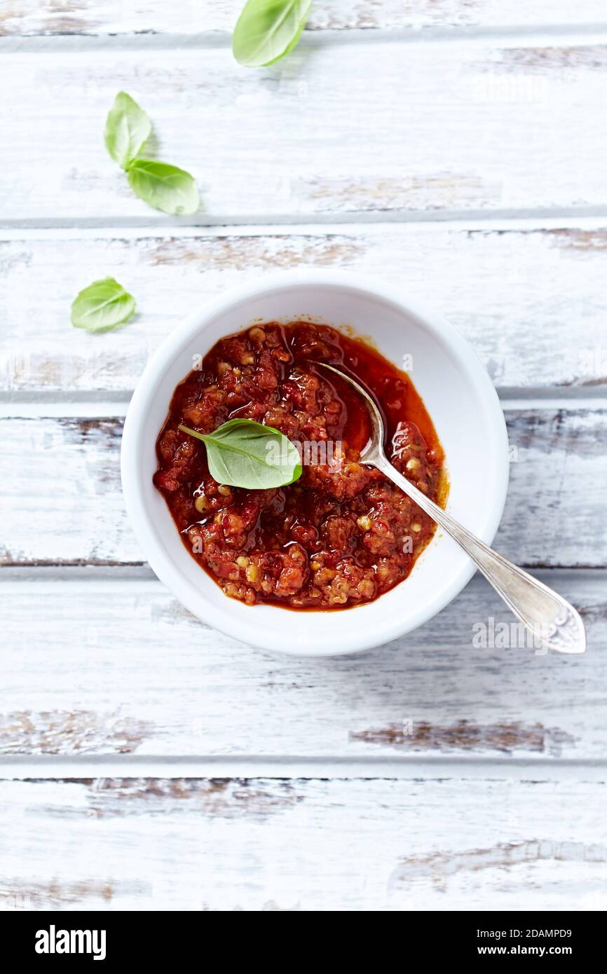 Spicy Tomato, Chilli and Pepper sauce salsa. Bright wooden background ...