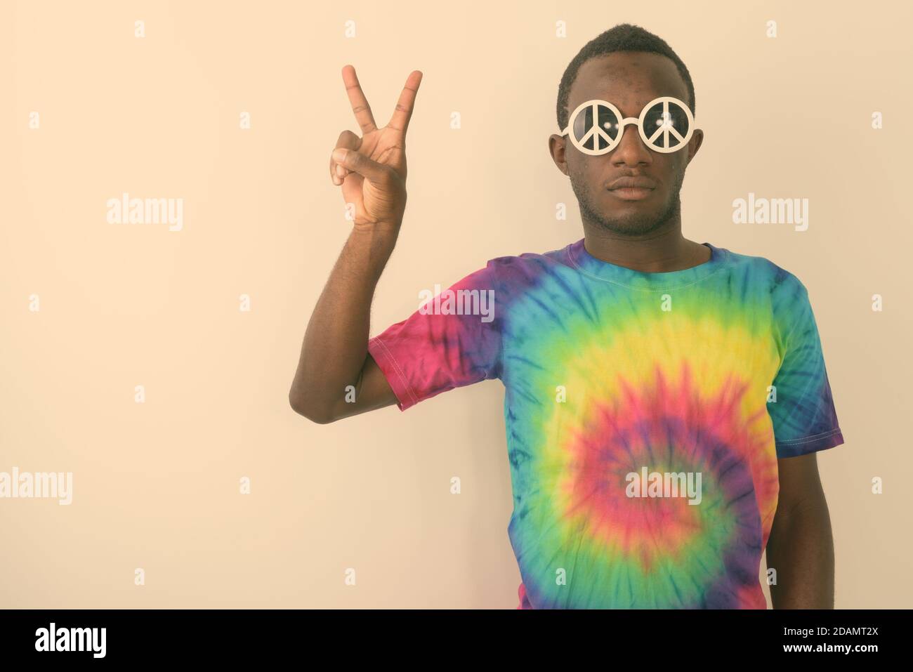 Young African man hippie wearing sunglasses with peace sign while ...
