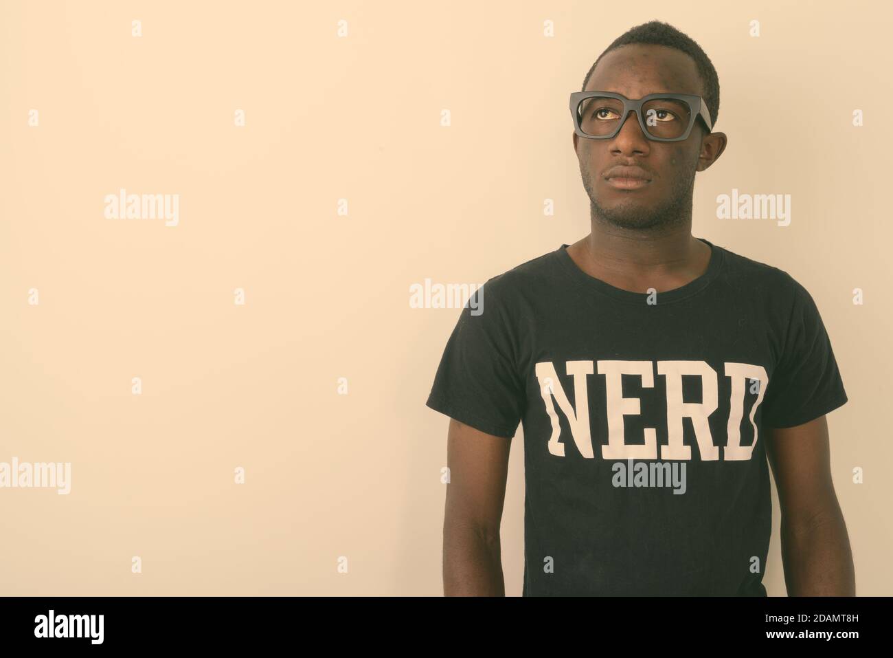 Studio shot of young black African geek man wearing Nerd shirt while ...