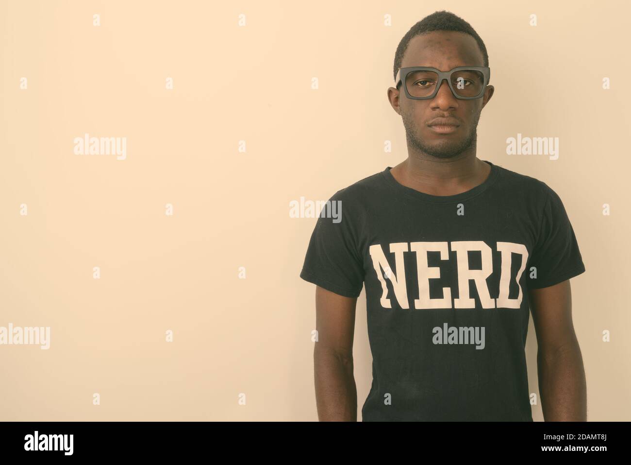 Studio shot of young black African geek man wearing Nerd shirt against ...