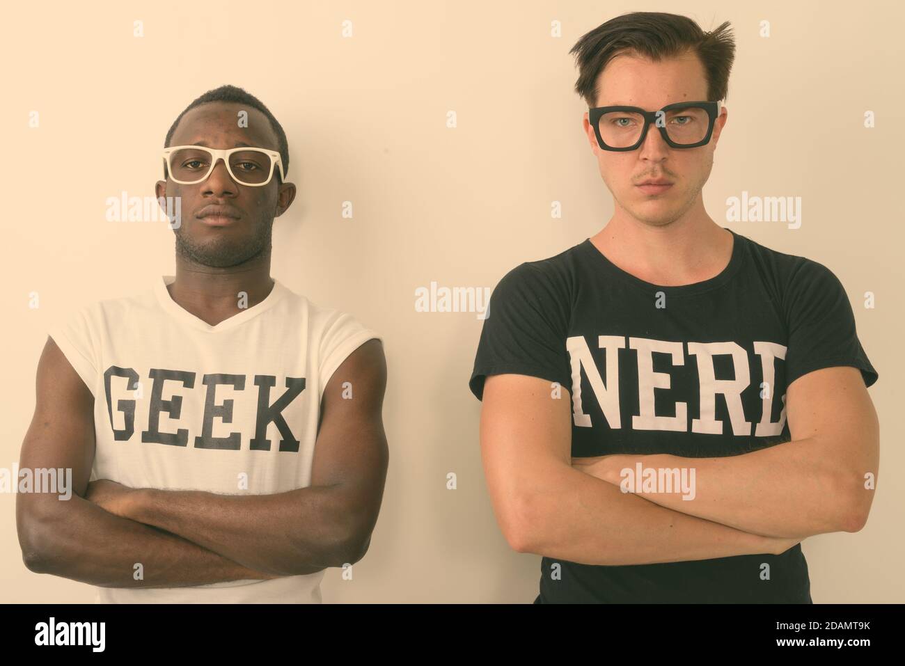 Studio shot of young black African Geek man with European Nerd man ...
