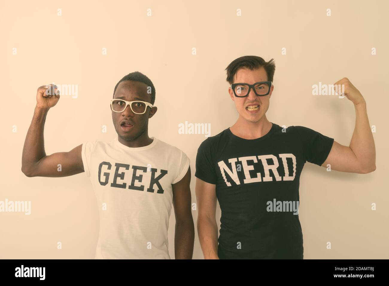 Studio shot of young black African Geek man with European Nerd man ...