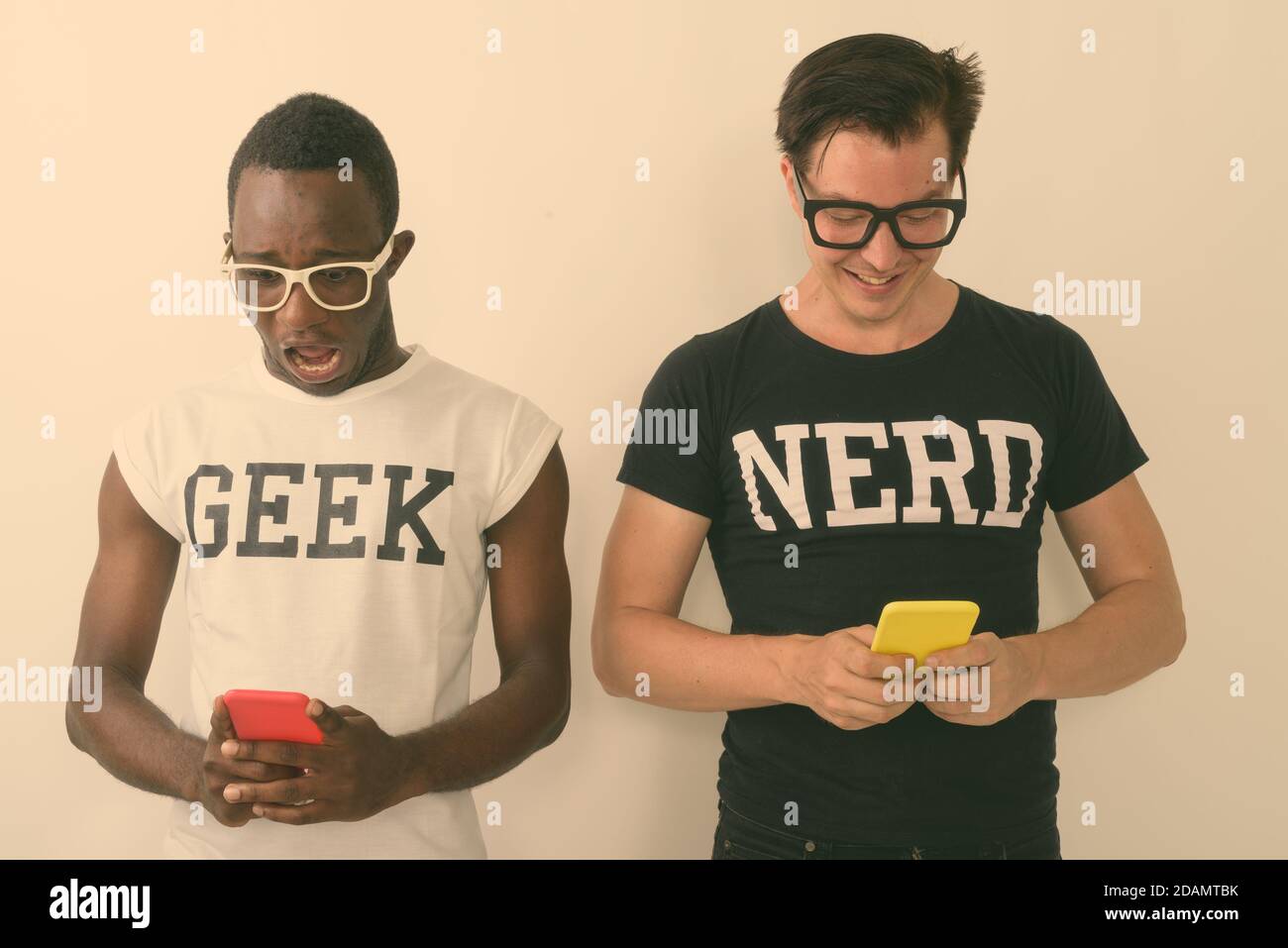 Young shocked black African Geek man using mobile phone while happy ...