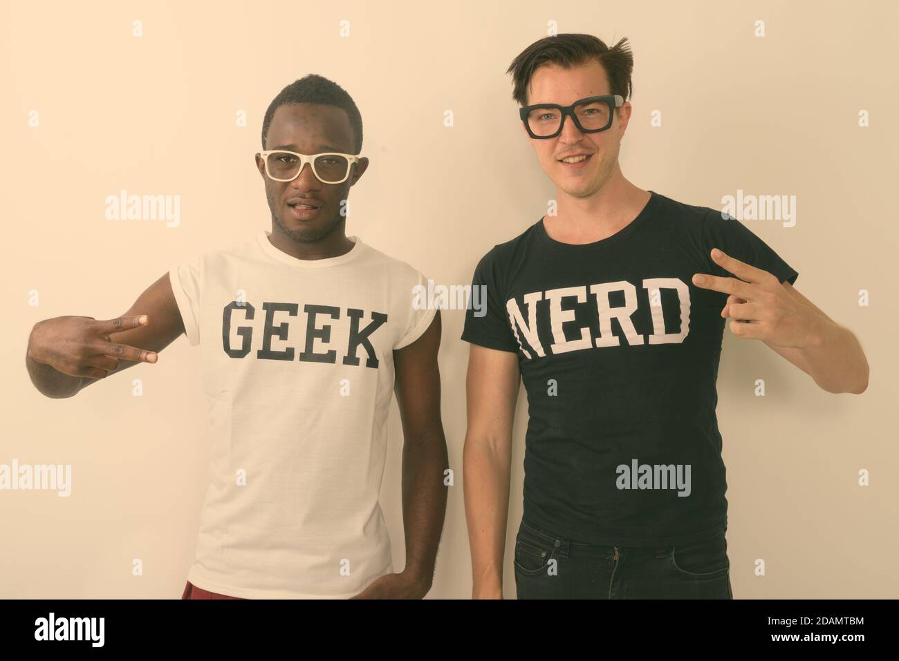 Studio shot of young happy black African Geek man with European Nerd ...