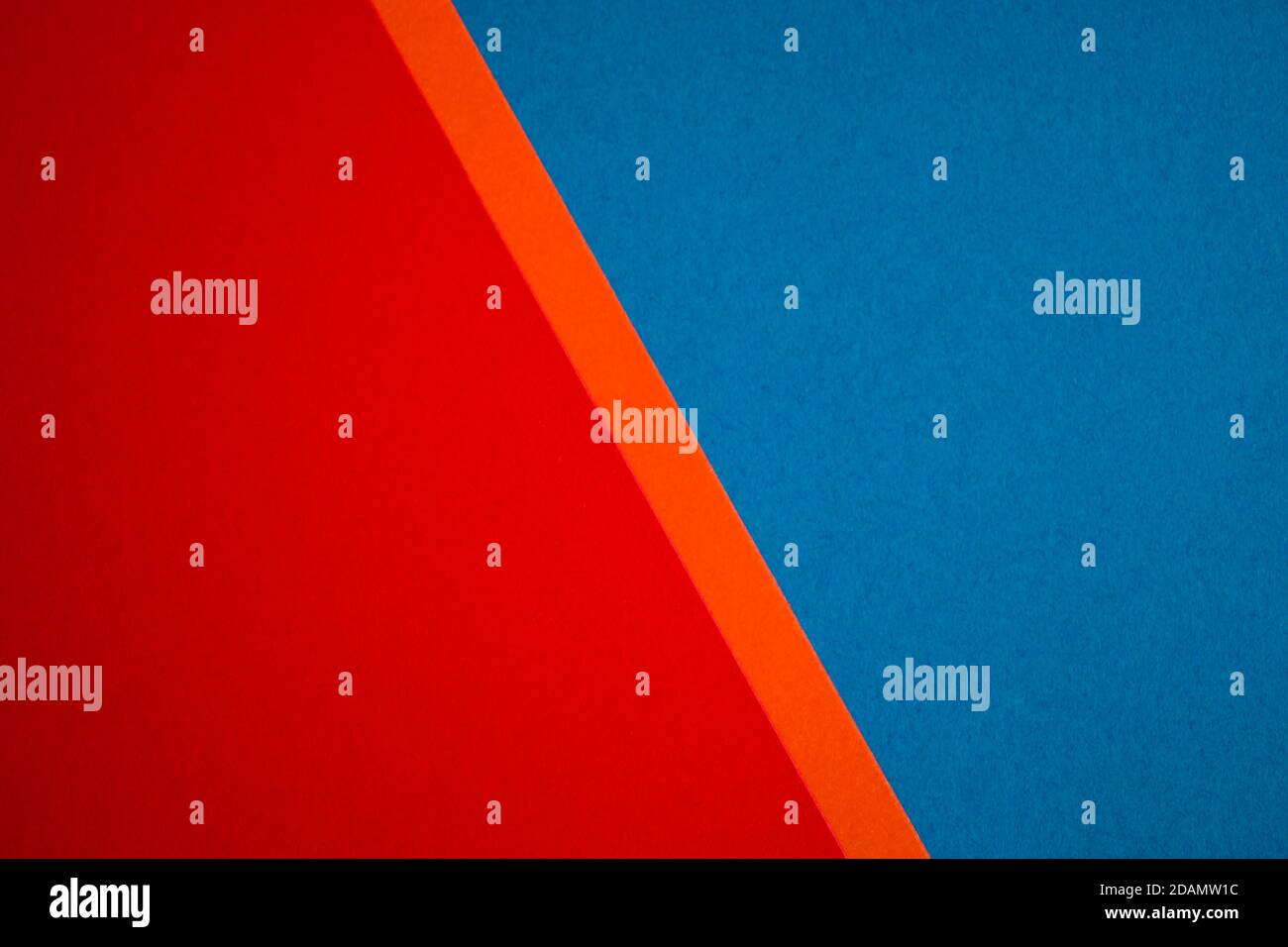 Blue and red diagonally divided colored paper background with orange ...