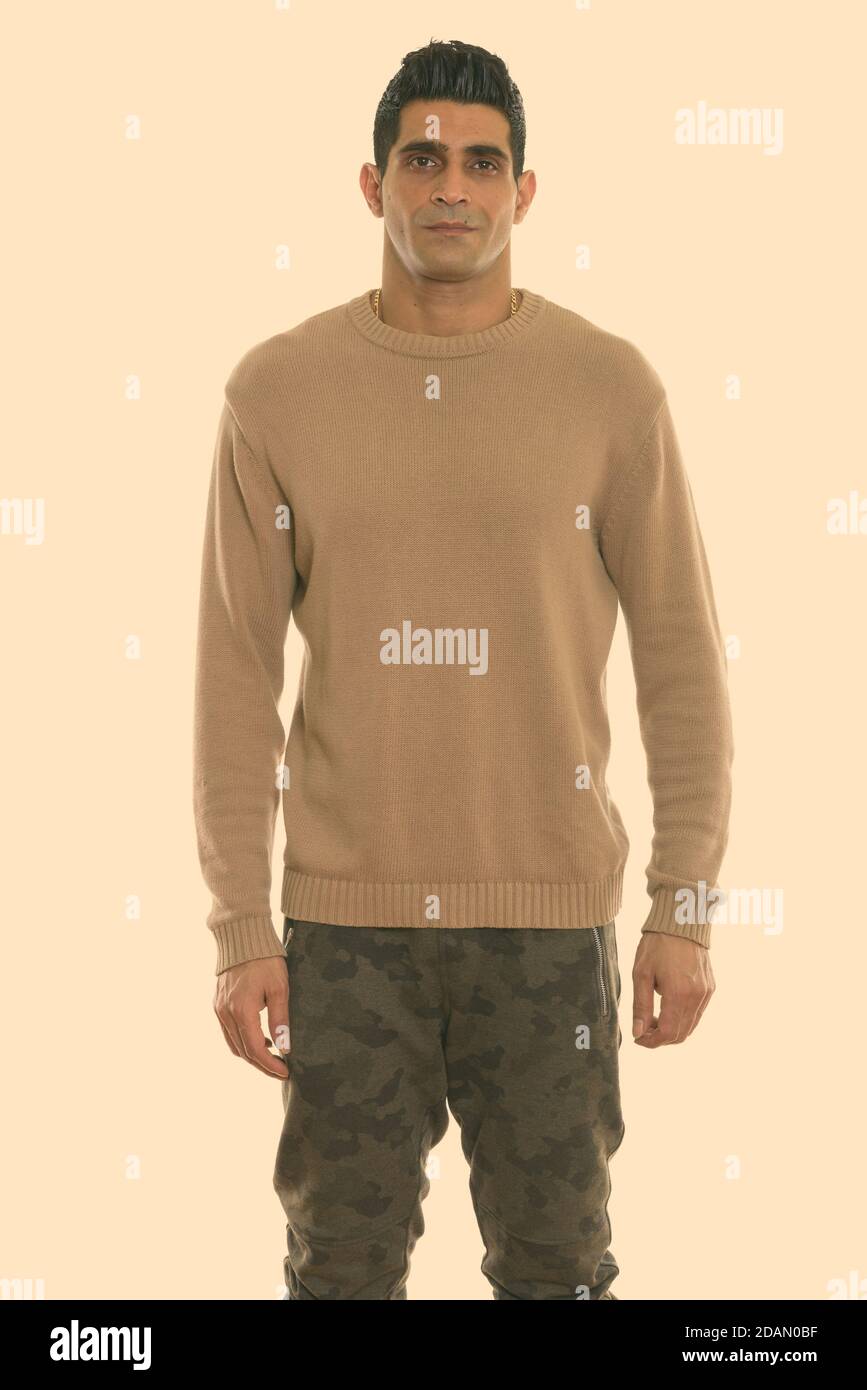 Studio shot of young muscular Persian man standing Stock Photo - Alamy