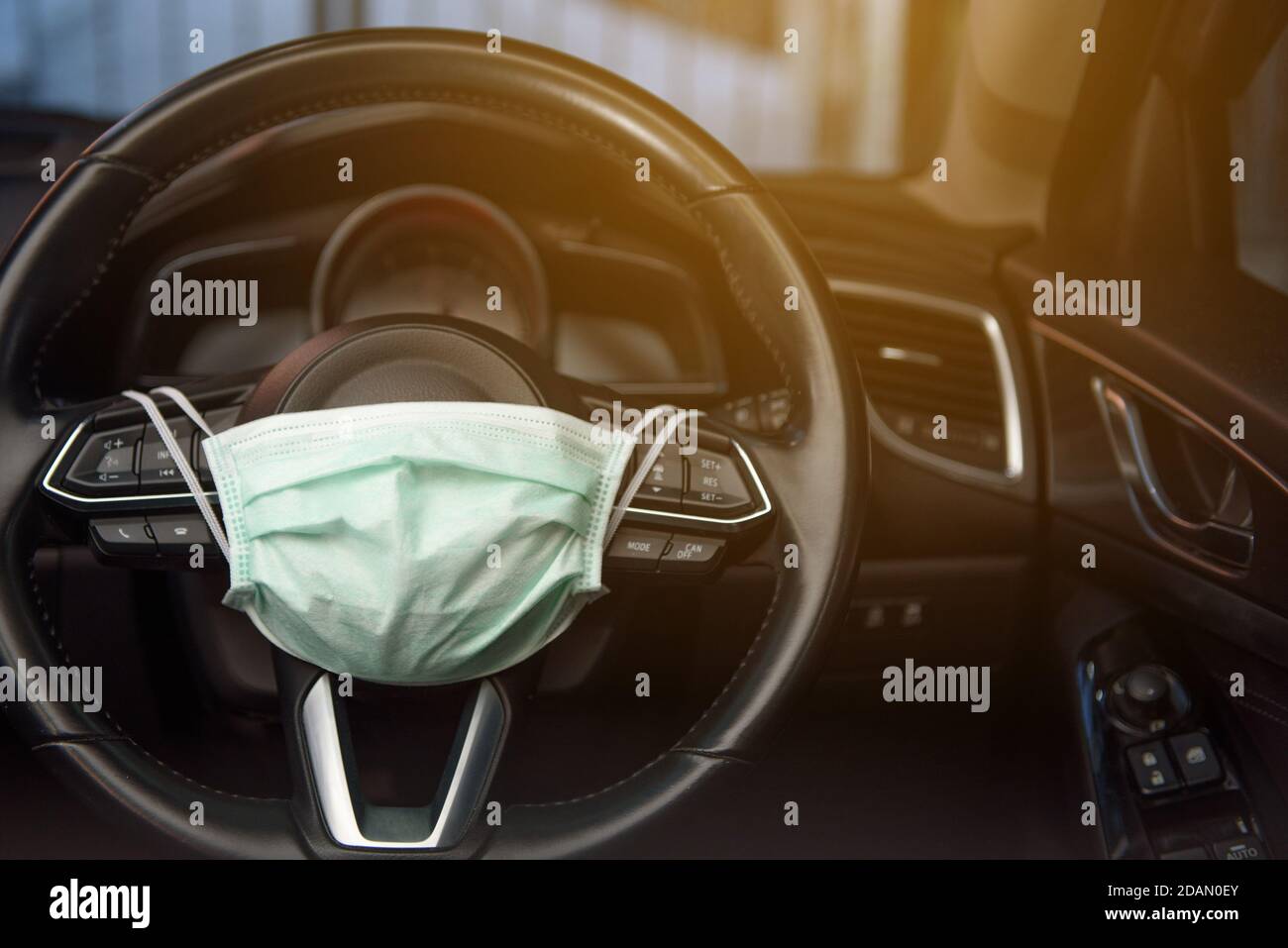 Surgical face mask put on the steering wheel in the car, concept for ...