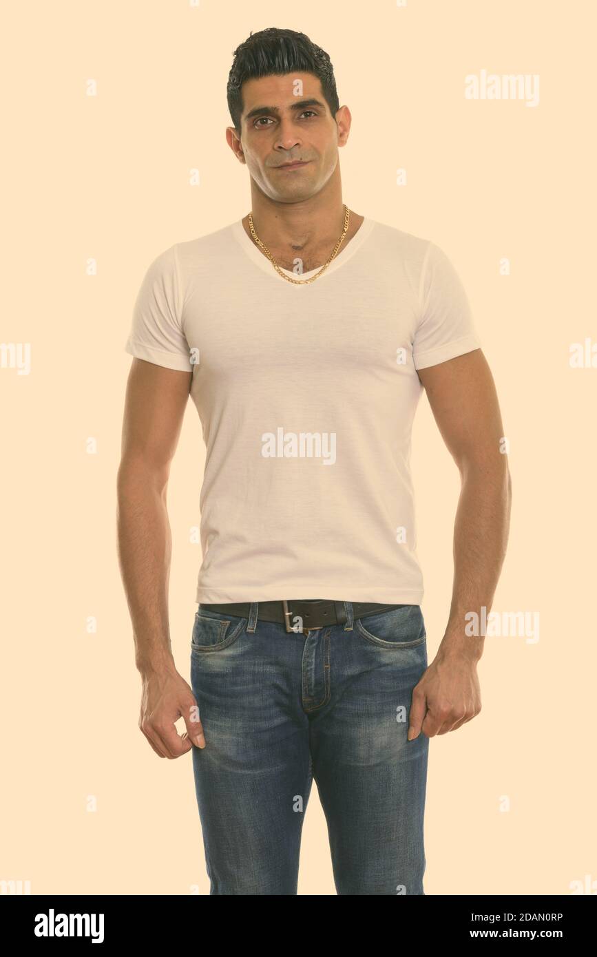Studio shot of young muscular Persian man standing Stock Photo - Alamy