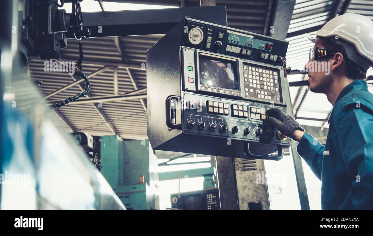 Smart factory worker using machine in factory workshop . Industry and ...