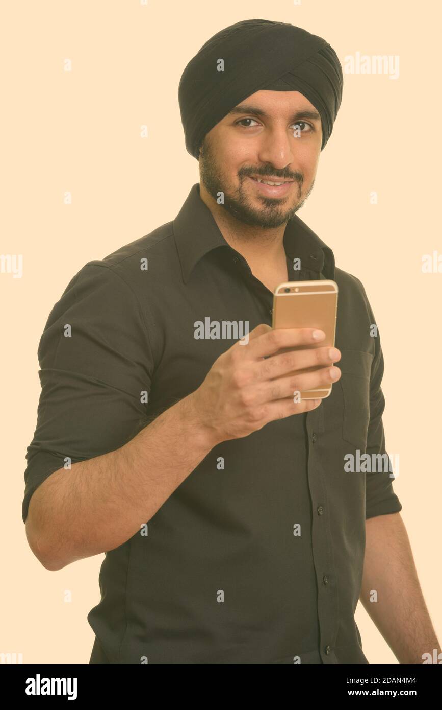Young happy Indian Sikh man holding mobile phone Stock Photo - Alamy