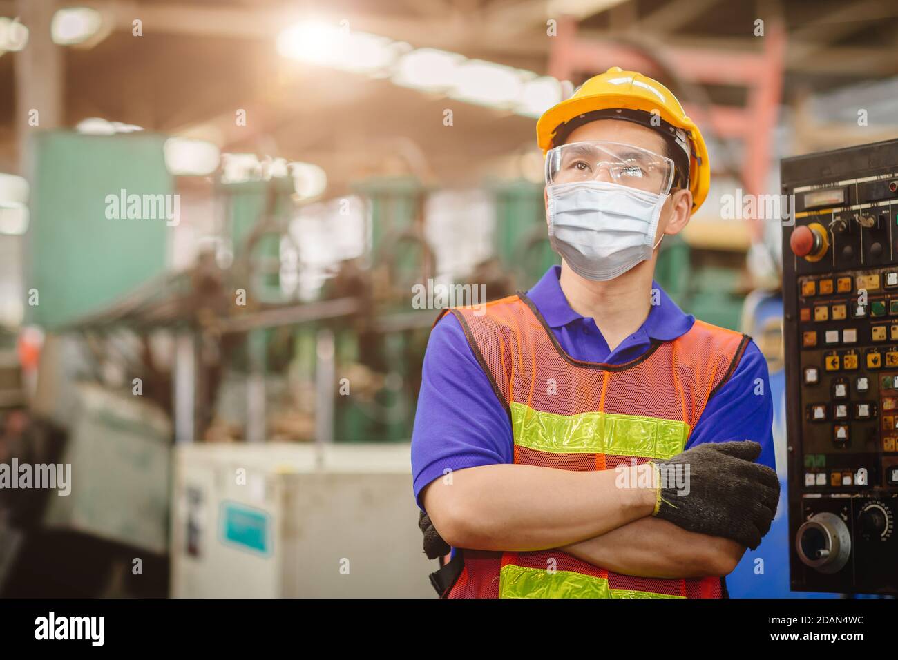 Asian worker wearing disposable face mask or HEPA face shield for ...