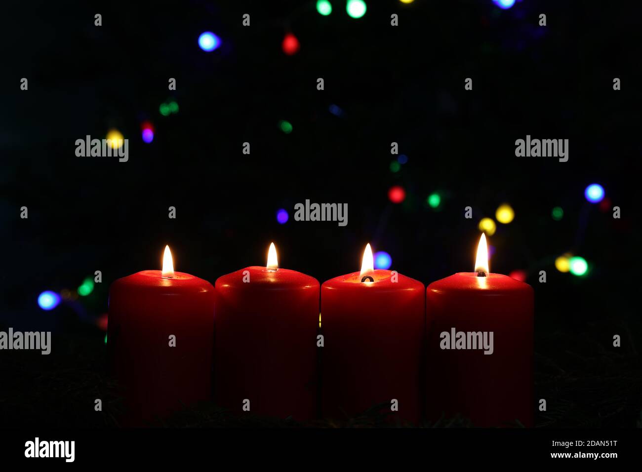 Shot of burning red advent candles on dark background Stock Photo - Alamy Shot of burning red advent candles on dark background Stock Photo - Alamy