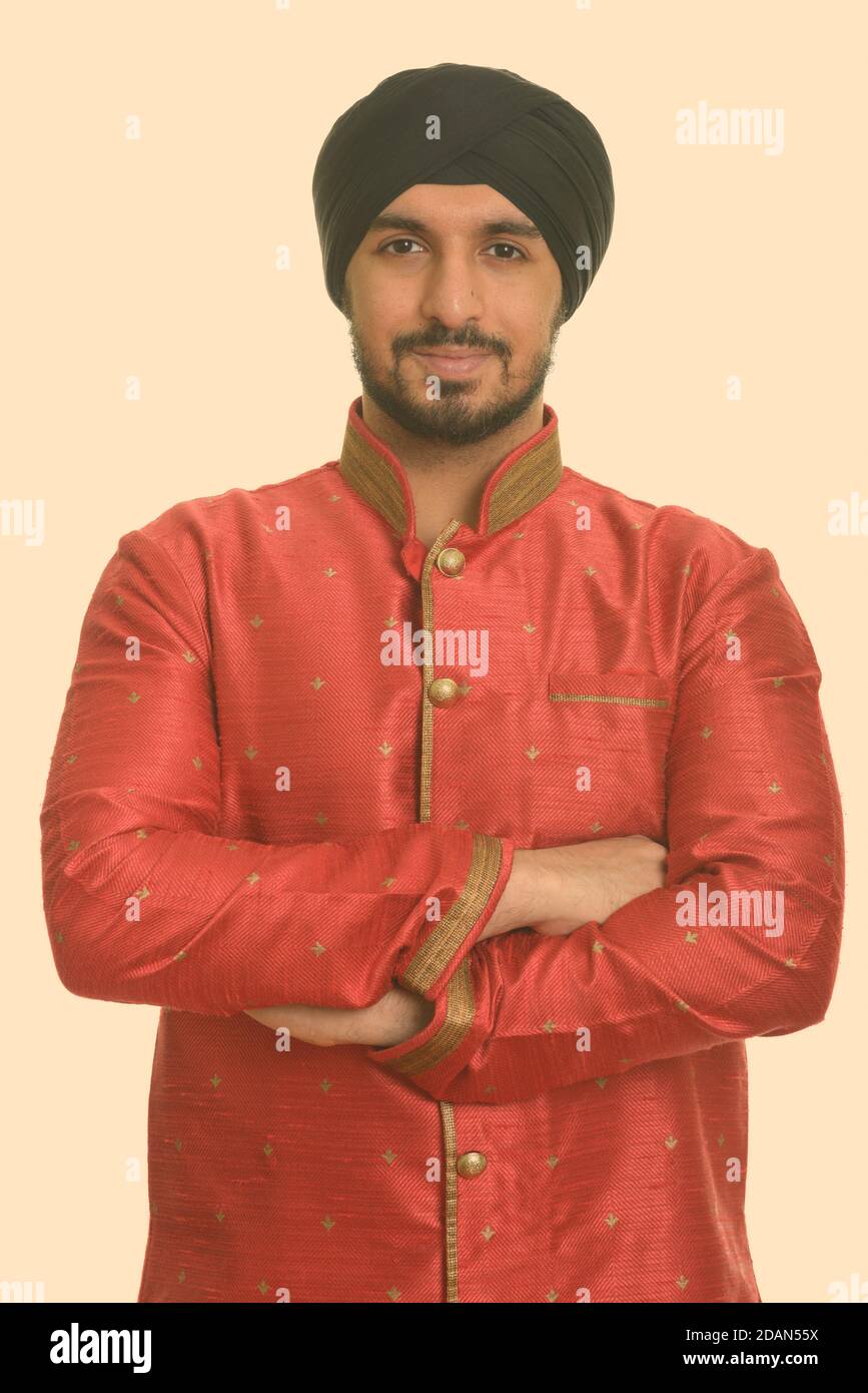 Young handsome Indian Sikh man wearing traditional clothes Stock Photo ...