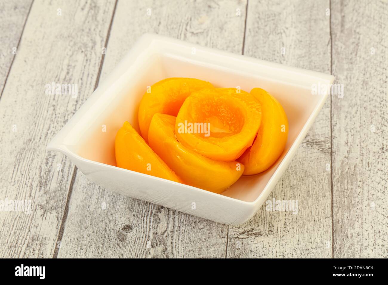 Marinated peaches fruit in the bowl with syrope Stock Photo - Alamy