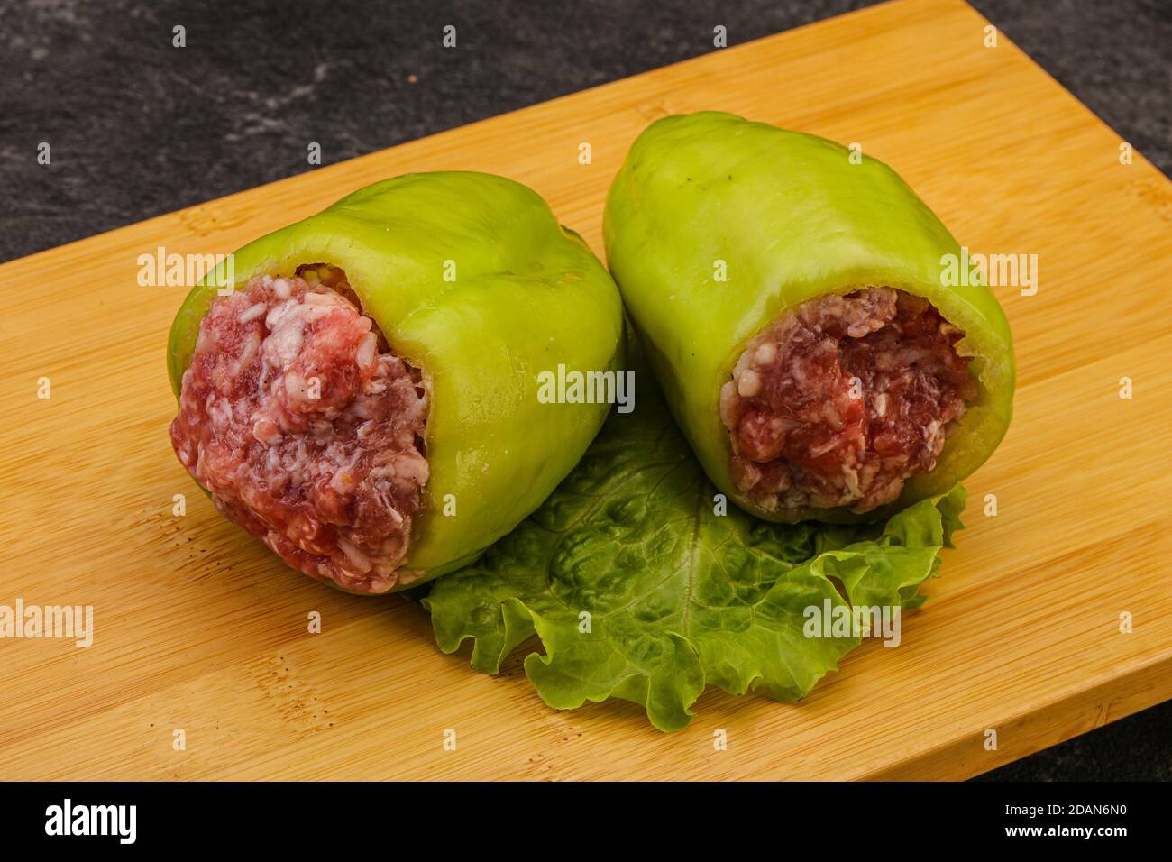 Raw stuffed green bell pepper with meat Stock Photo - Alamy