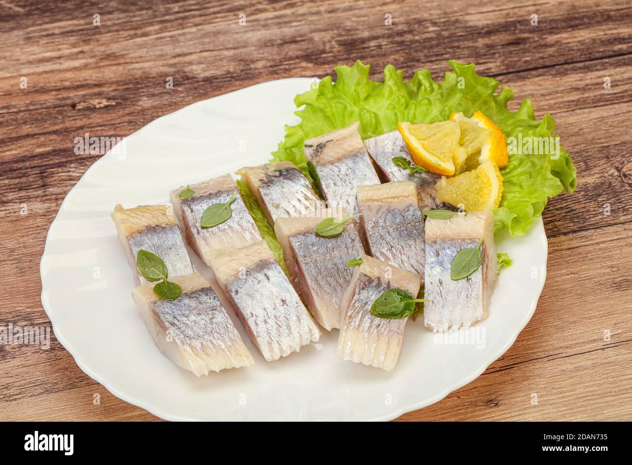 Marinated Herring fillet with sliced lemon Stock Photo - Alamy