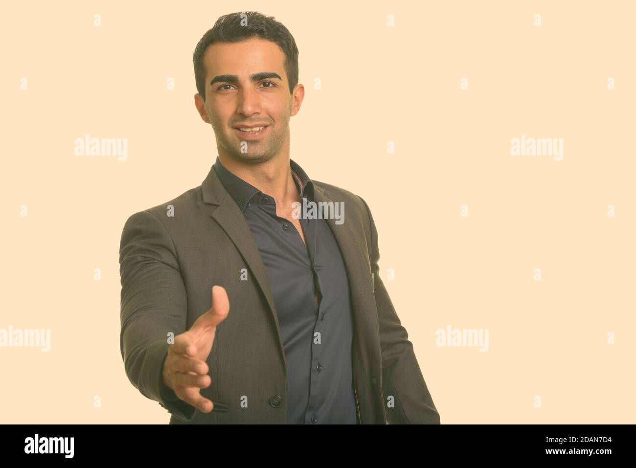 Young happy Iranian businessman giving handshake Stock Photo - Alamy