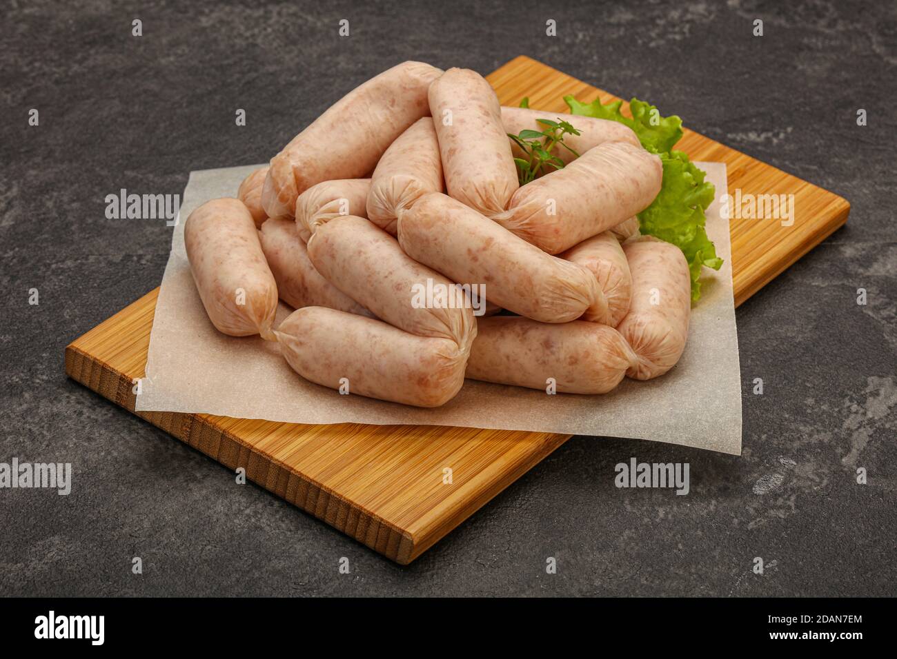 Raw natural chicken baby sausages for roast Stock Photo - Alamy