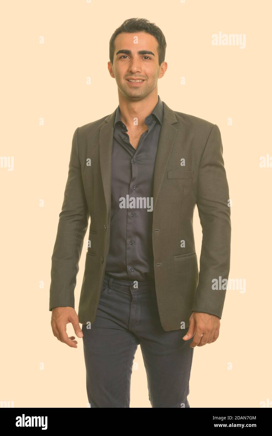 Young happy Iranian businessman smiling Stock Photo - Alamy