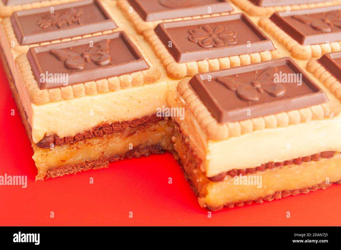 rectangle brown cake section with biscuits, apples and pudding Stock ...