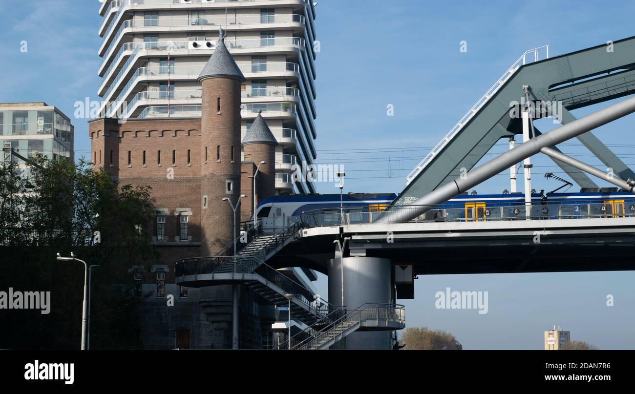 Dutch passenger train passing a blue bridge in Nijmegen, Gelderland ...
