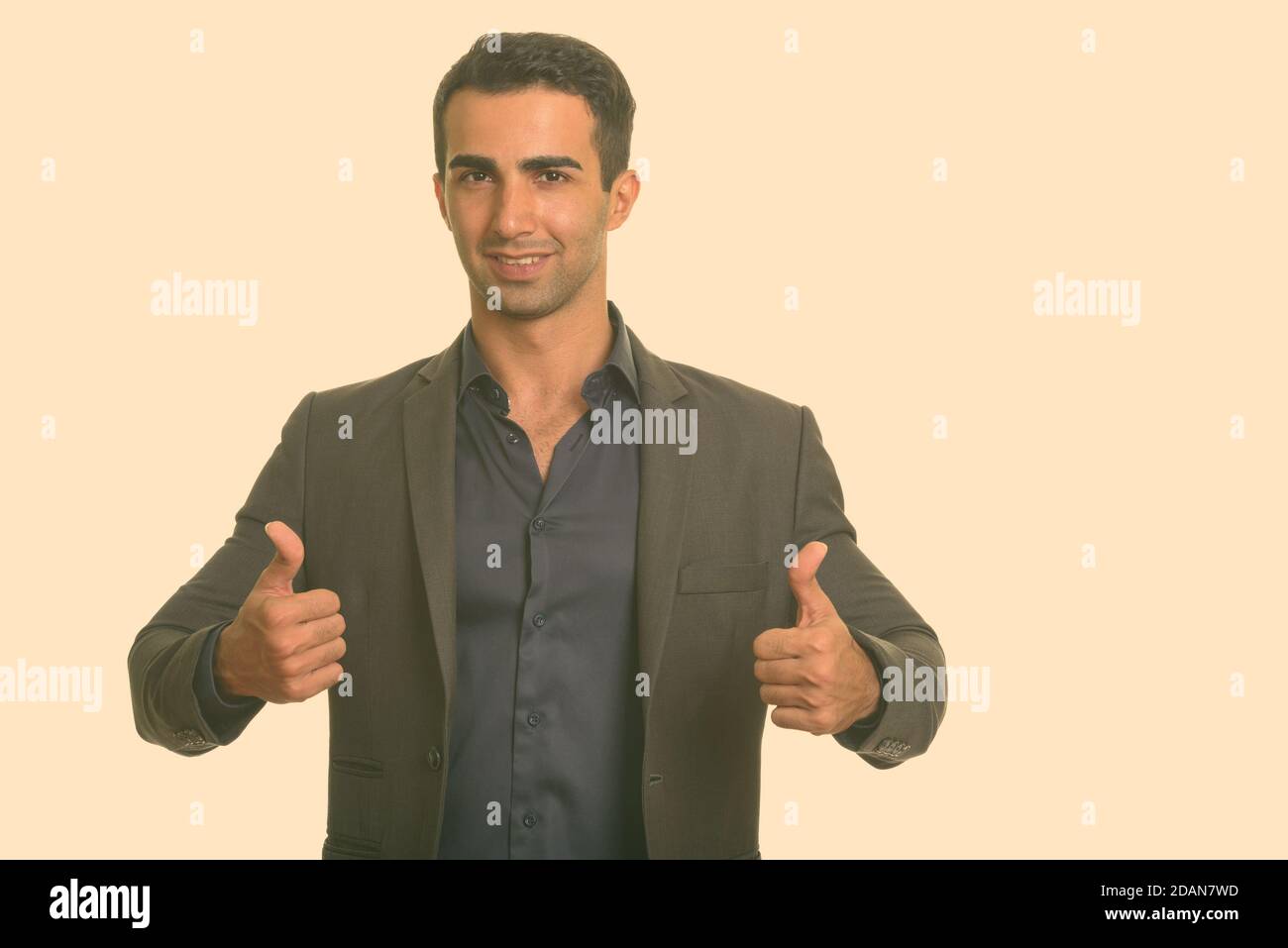 Young happy Iranian businessman giving thumbs up Stock Photo - Alamy