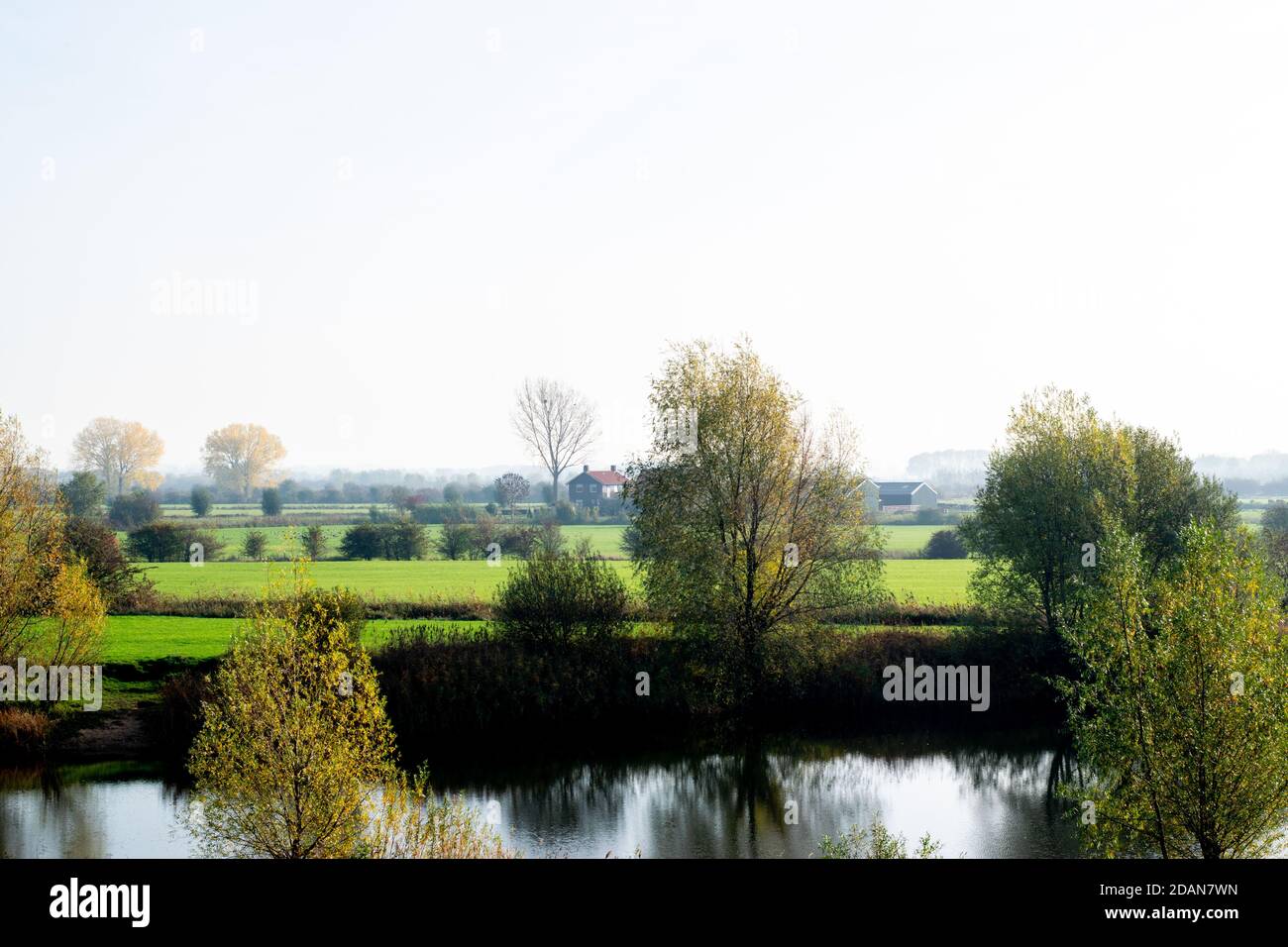 Old Dutch house standing in front of a small river in a Dutch polder ...