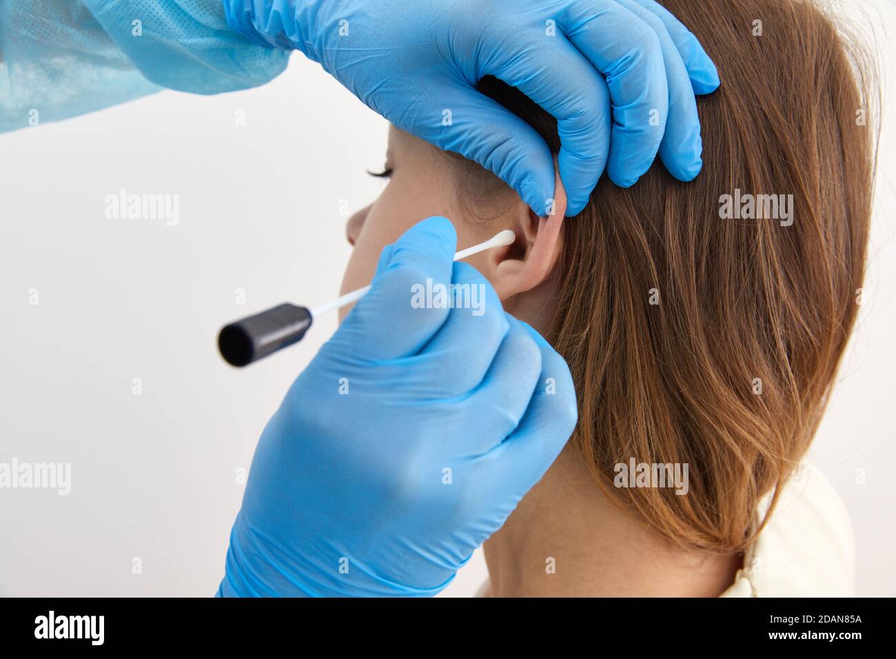 Ear check with cotton bud in medical laboratory Stock Photo - Alamy