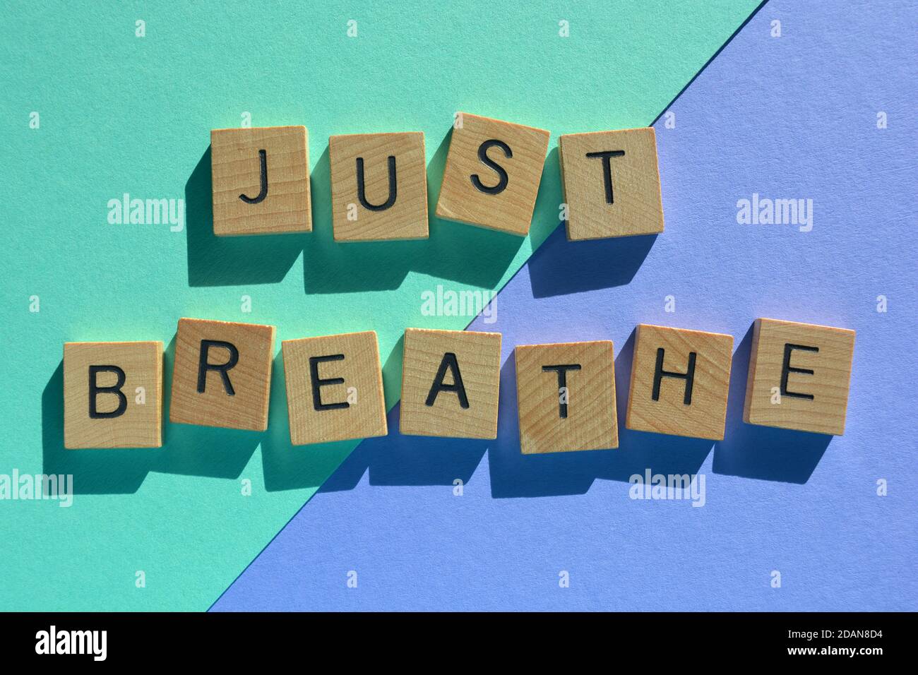 ust Breathe, phrase in wooden alphabet letters isolated on colourful ...