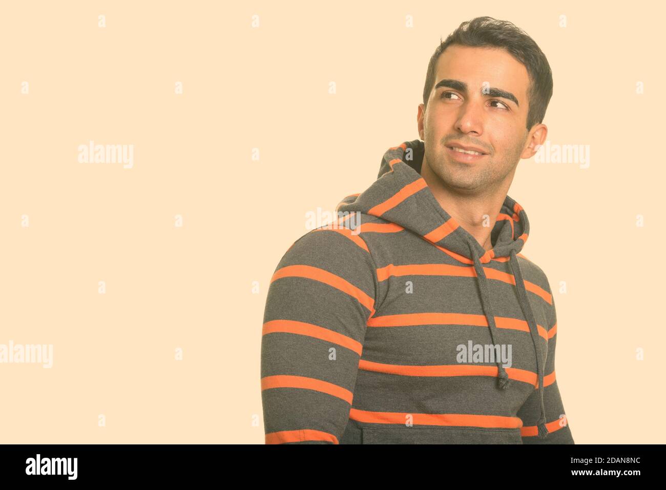 Young happy Iranian man thinking Stock Photo - Alamy