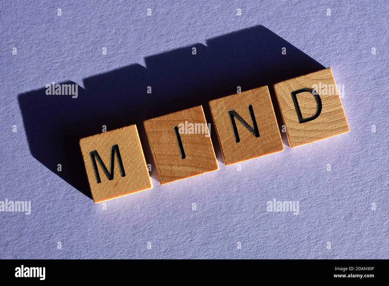 Mind, word in wooden alphabet letters isolated on purple background ...