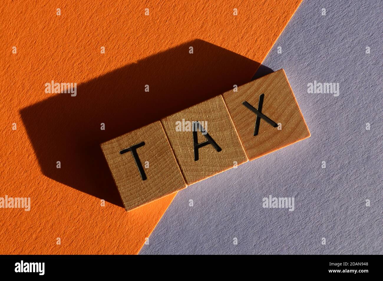 Tax, word in wooden alphabet letters isolated on colourful background ...