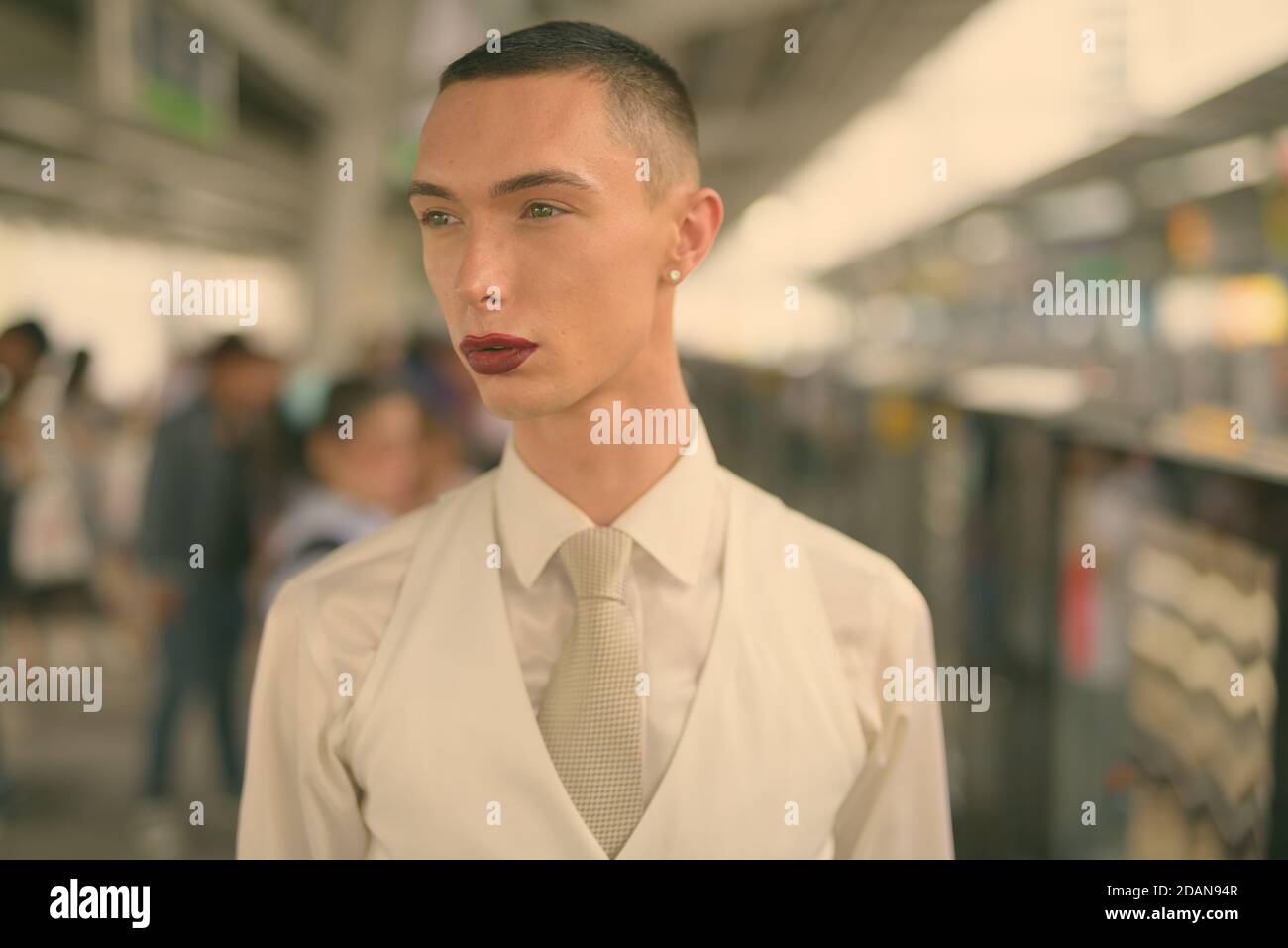 Young handsome androgynous businessman exploring the city of Bangkok ...