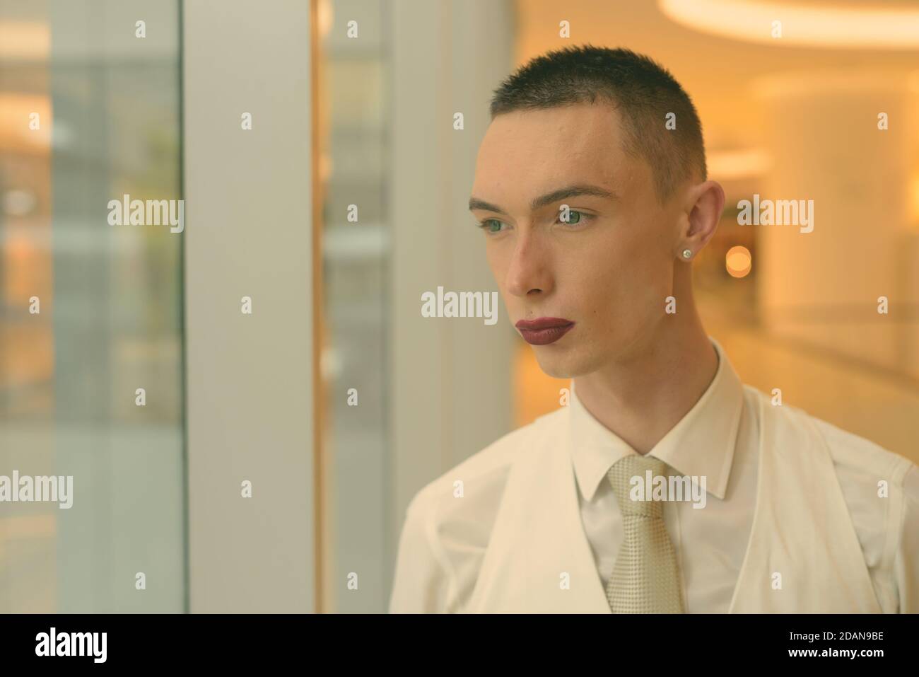 Young handsome androgynous businessman exploring the city of Bangkok ...
