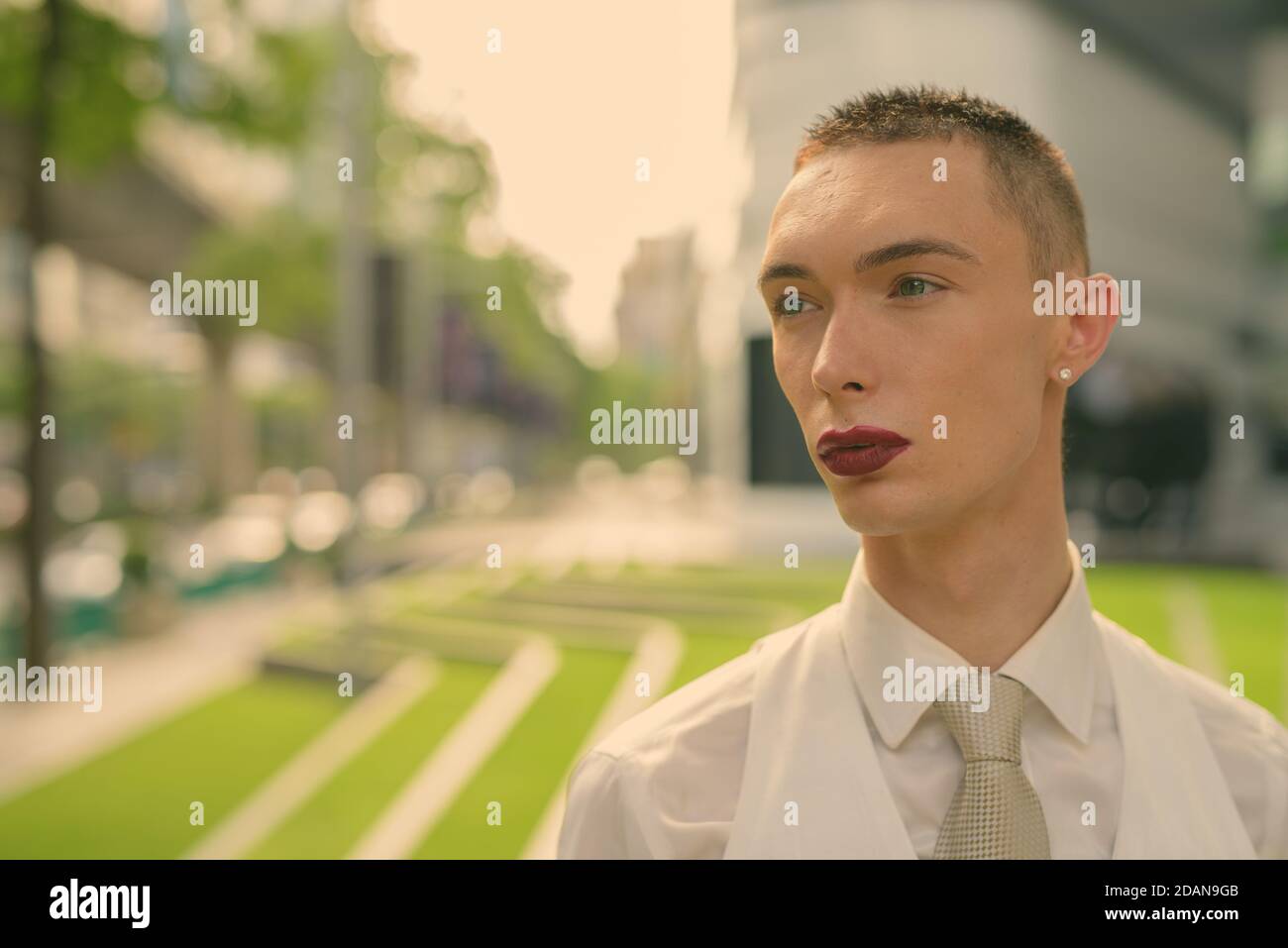 Young handsome androgynous businessman exploring the city of Bangkok ...