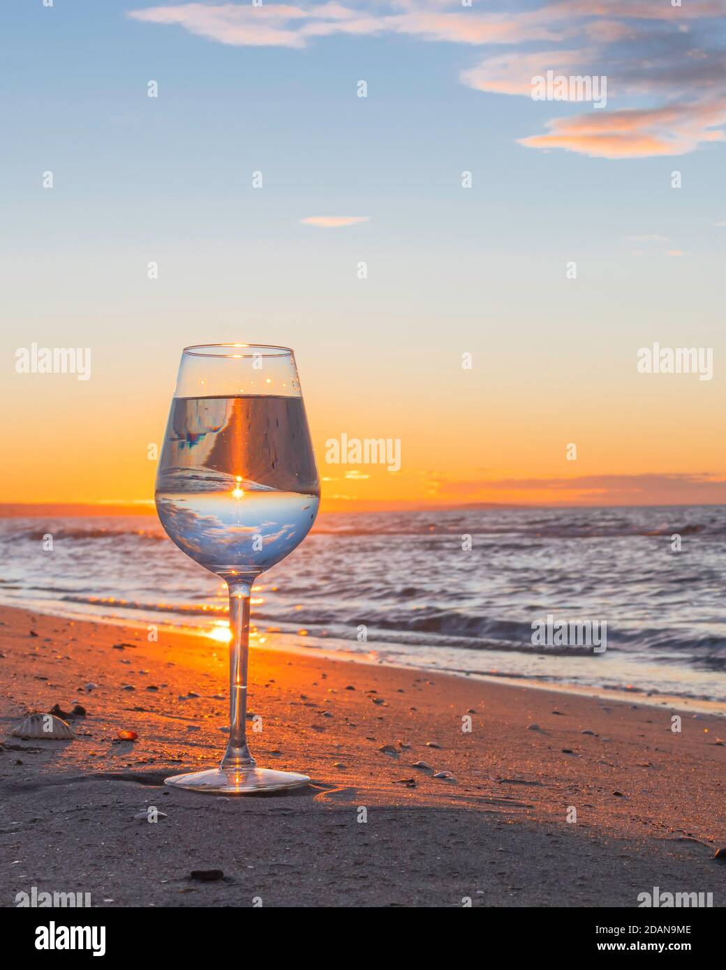 Reflection in a glass at sunset on a beach Stock Photo - Alamy