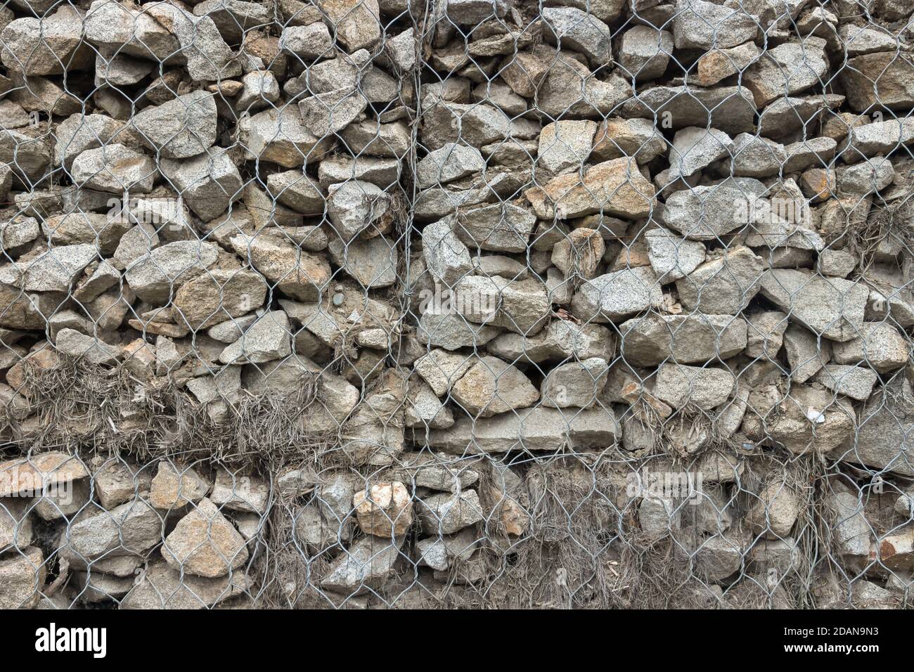 Gabion fence from mesh with stones Stock Photo - Alamy