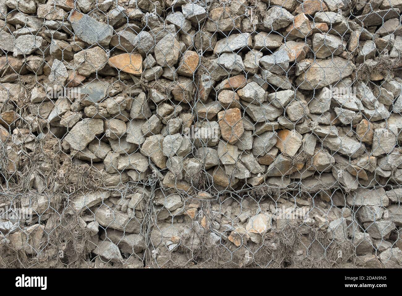 Gabion fence from mesh with stones Stock Photo - Alamy
