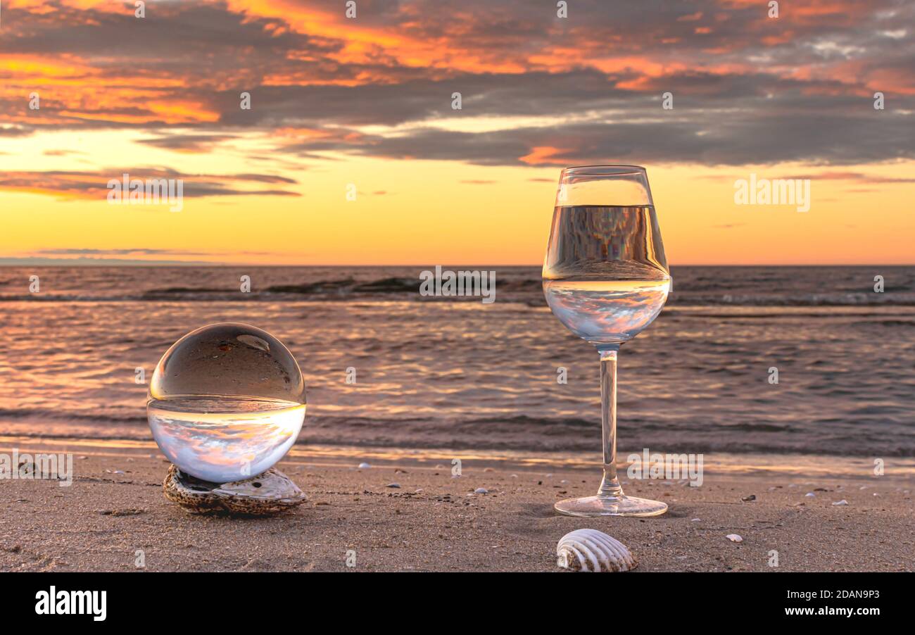 Reflection in a glass at sunset on a beach Stock Photo - Alamy