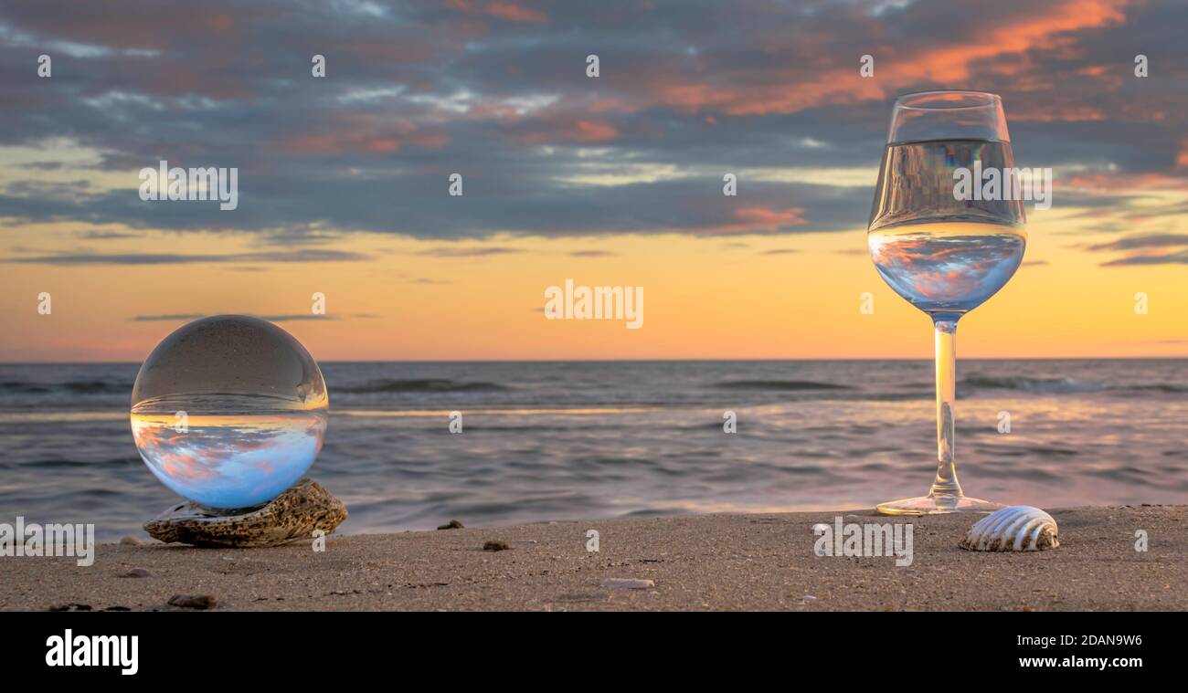 Reflection in a glass at sunset on a beach Stock Photo - Alamy