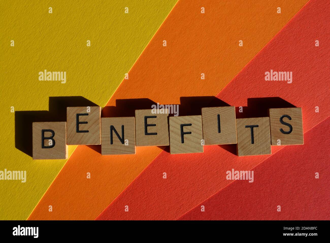 Benefits, word in wooden alphabet letters isolated on colourful ...