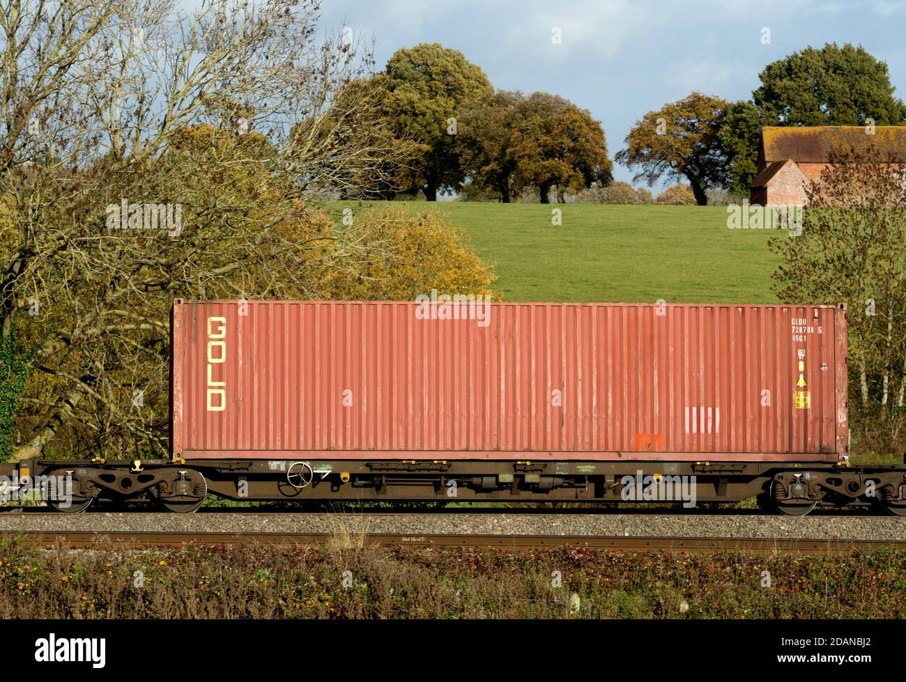 A Gold shipping container on a freightliner train, Warwickshire, UK ...