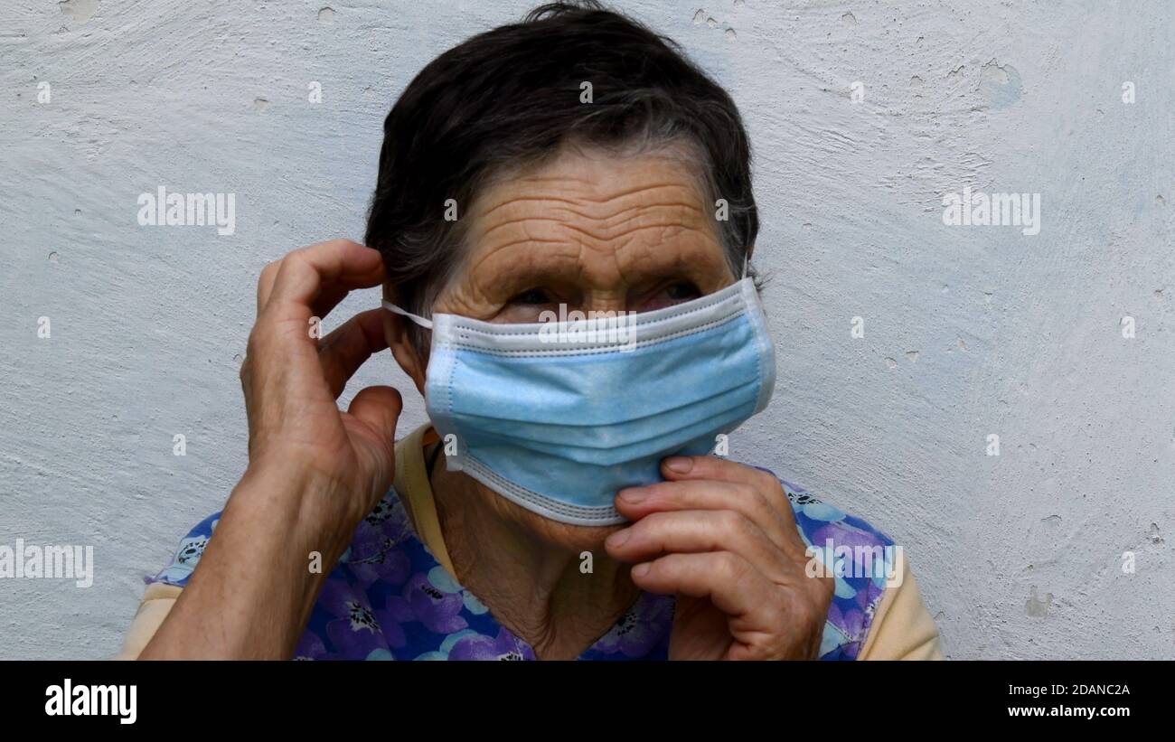Old lady shows wear mask hi-res stock photography and images - Alamy