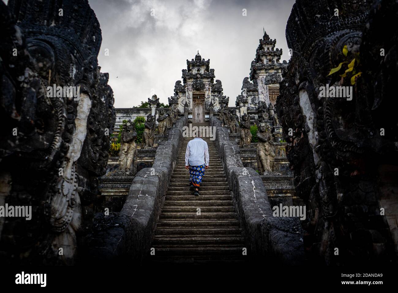 man goes up the stairs to temple Stock Photo - Alamy