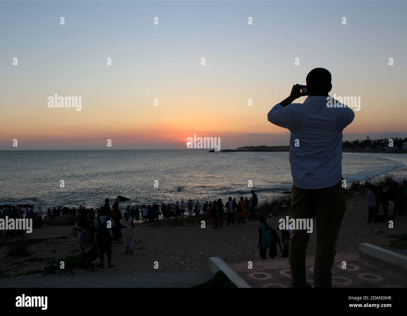 Indian gentleman at Kanyakumari taking a photograph of the sunset Stock ...