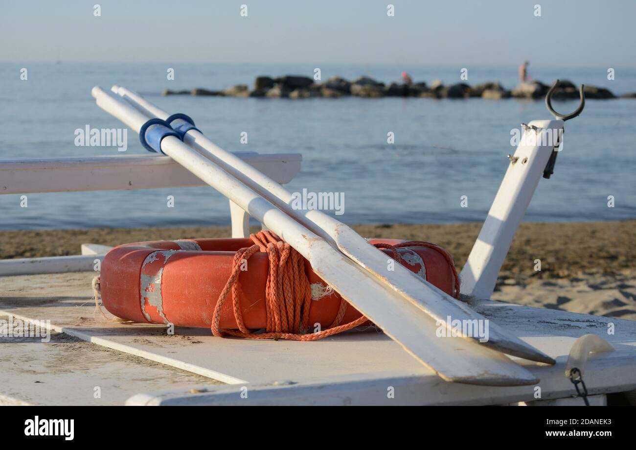 two oars and a life buoy of a lifeguard boat Stock Photo - Alamy
