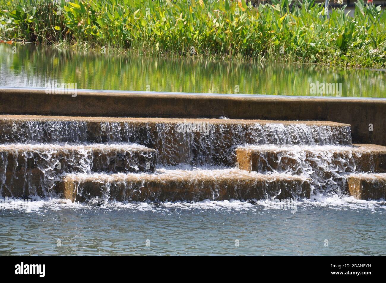Artificial water feature created by water cascading over large stone ...