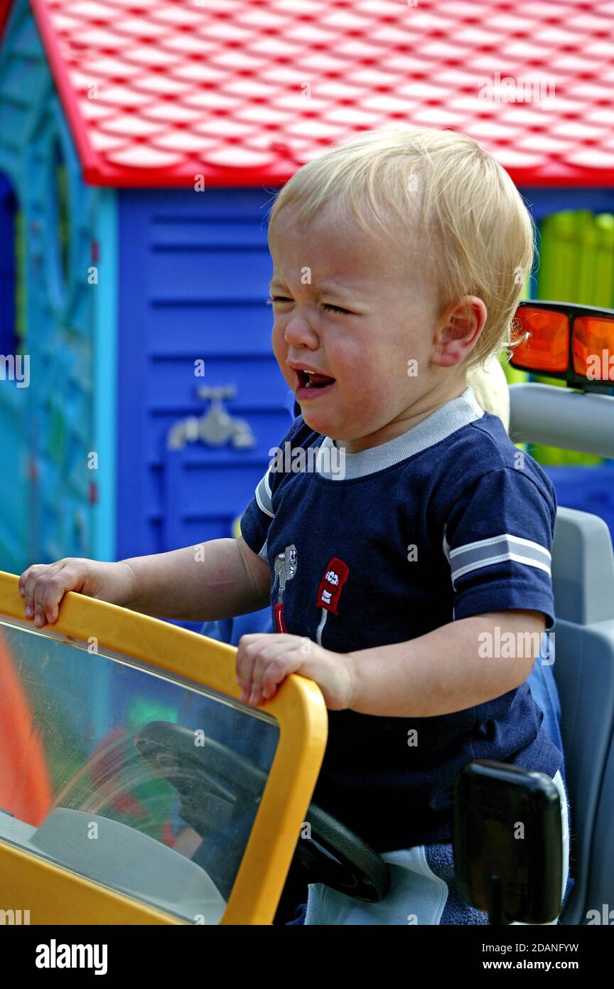 BOY CRYING, PLAYING WITH TOY CAR Stock Photo - Alamy
