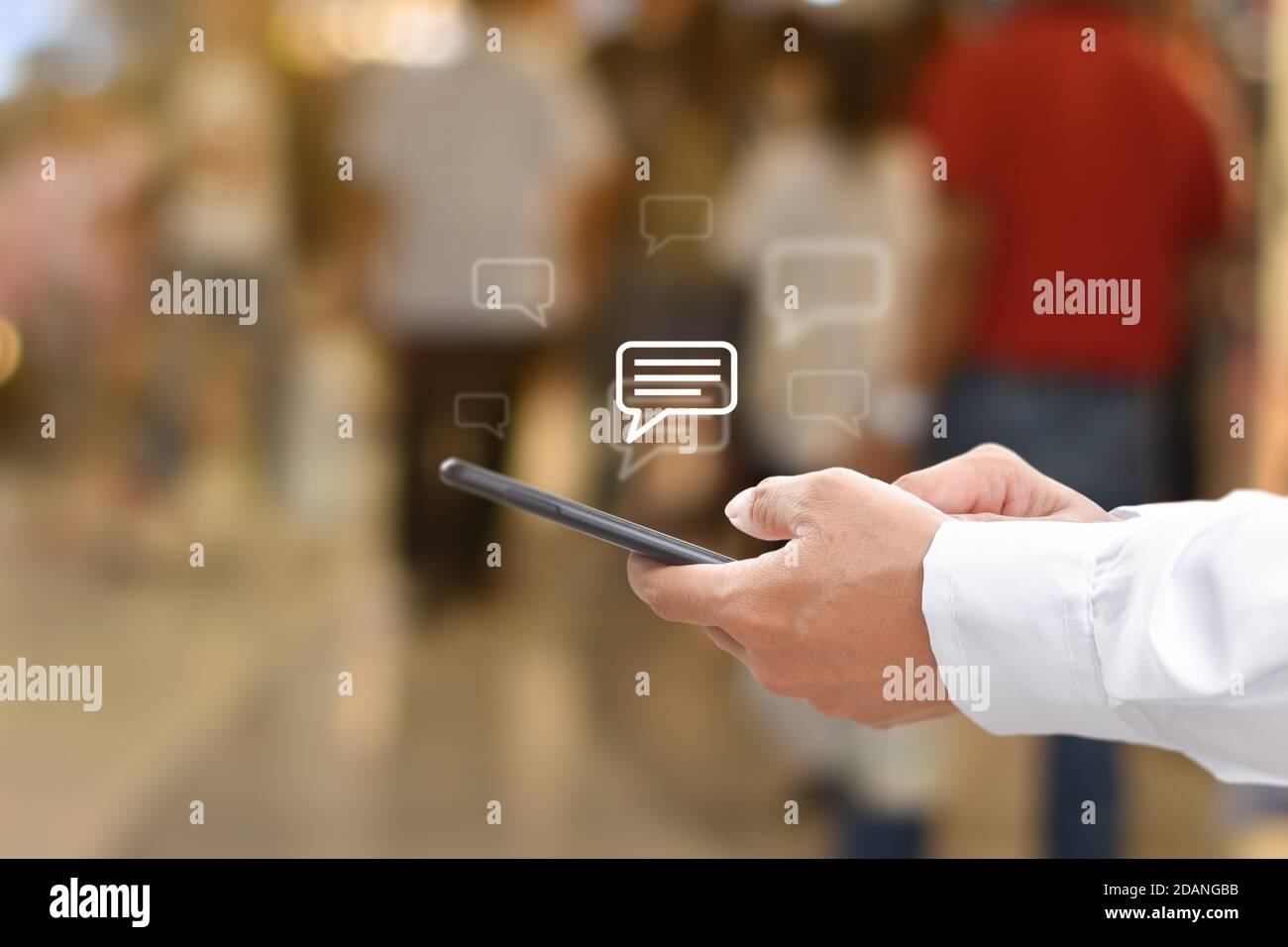 Hand using mobile phone typing, with chat icons. Social media and ...