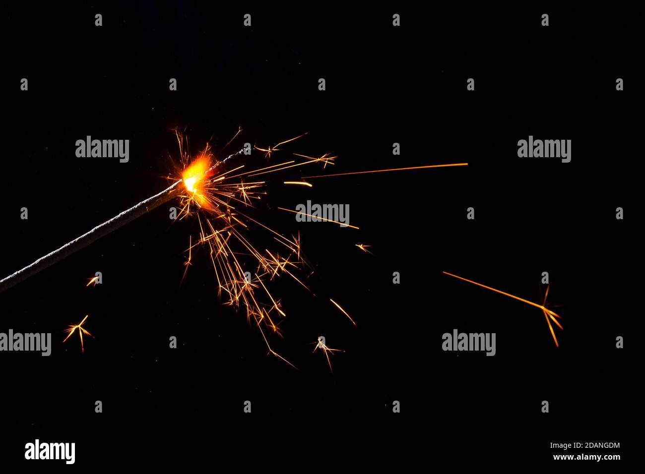 A lit sparkler showing bright sparks desing abstract Stock Photo - Alamy